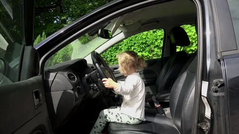 Cute little girl get inside car and play... | Stock Video | Pond5