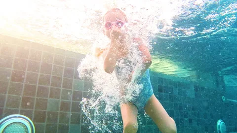 Cute little girl jumping in the swimming... | Stock Video | Pond5