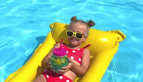 Cute little girl lying on inflatable mat... | Stock Video | Pond5