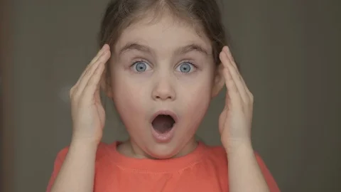 Cute little girl open her face with hand... | Stock Video | Pond5