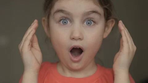 Cute little girl open her face with hand... | Stock Video | Pond5