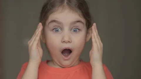 Cute little girl open her face with hand... | Stock Video | Pond5