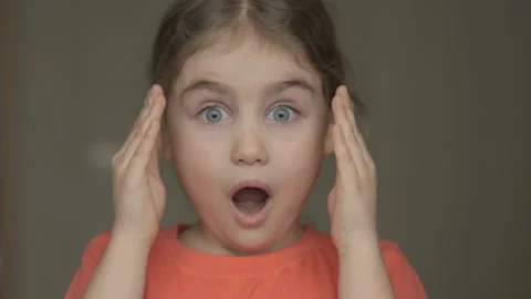 Cute little girl open her face with hand... | Stock Video | Pond5