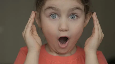 Cute little girl open her face with hand... | Stock Video | Pond5