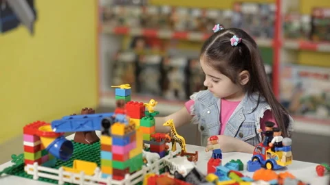 Cute little girl is playing with objects... | Stock Video | Pond5