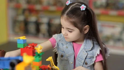 Cute little girl is playing with objects... | Stock Video | Pond5