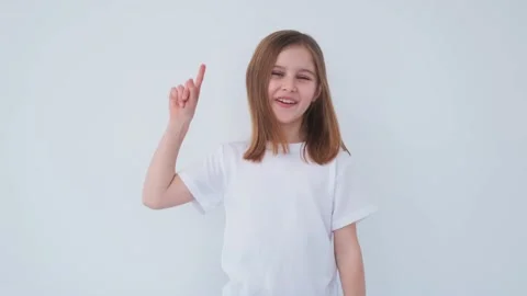 Cute little girl pointing by finger | Stock Video | Pond5