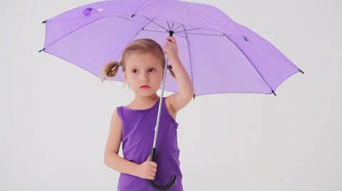 Cute little girl in a purple clothes fol... | Stock Video | Pond5