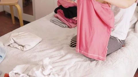 Cute little girl sorting clothes in her ... | Stock Video | Pond5