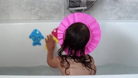 The cute little girl is taking a bath an... | Stock Video | Pond5