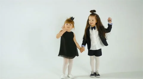 Cute Little Girls Wave At The Camera, Is... | Stock Video | Pond5