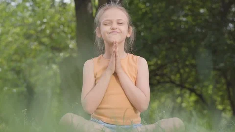 Cute little ute girl sitting on the gras... | Stock Video | Pond5