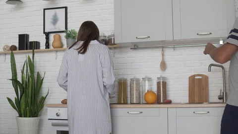 Cute morning lovers in the kitchen. | Stock Video | Pond5