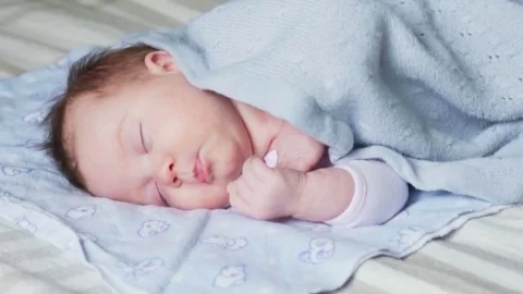 Cute newborn baby sleeping on a bed | Stock Video | Pond5