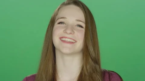 Cute redhead smiling, on a green screen ... | Stock Video | Pond5