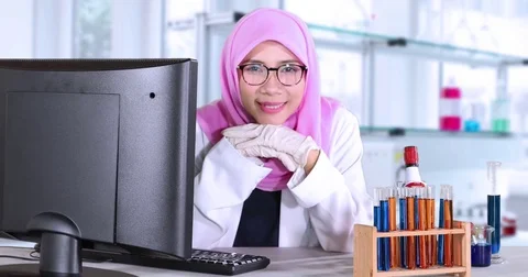 Cute scientist smiling in laboratory | Stock Video | Pond5