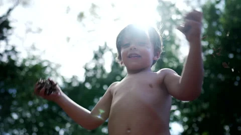 Cute shirtless little boy playing outsid... | Stock Video | Pond5