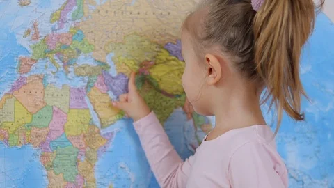 Cute smiling baby searching place on wor... | Stock Video | Pond5