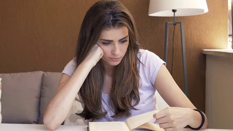 Cute student reading book concentrated c... | Stock Video | Pond5