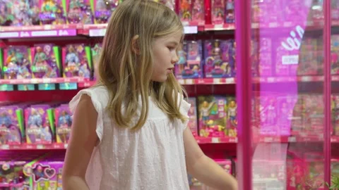 Cute teenage girl in a toy store in the ... | Stock Video | Pond5