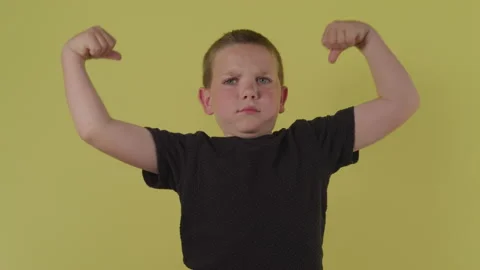 Cute Young Kid Flexing His Muscles in Fr... | Stock Video | Pond5
