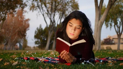 A cute young woman reading a story book ... | Stock Video | Pond5
