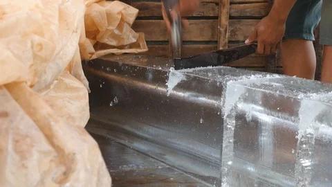 Cutting block of ice to smaller pieces w... | Stock Video | Pond5