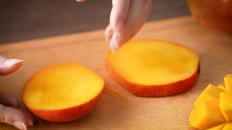 Cutting fresh mango fruit and showing th... | Stock Video | Pond5