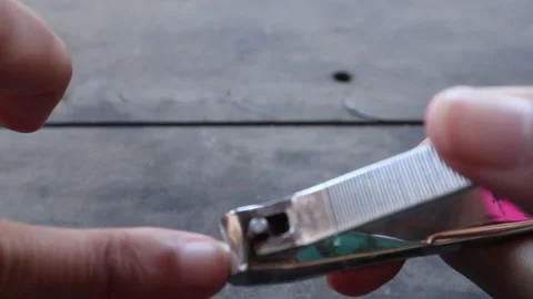 cutting his long fingernails | Stock Video | Pond5