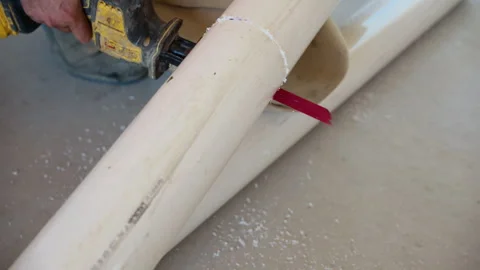 Cutting a large PVC pipe with an electri... | Stock Video | Pond5