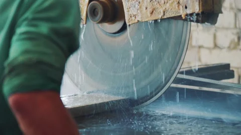 Cutting a stone slab of sandstone with a... | Stock Video | Pond5