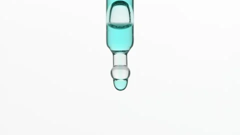 Cyan drops are falling down from lab dro... | Stock Video | Pond5