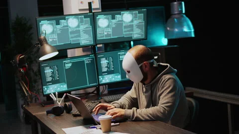 Cyber impostor wearing mask hacking data... | Stock Video | Pond5