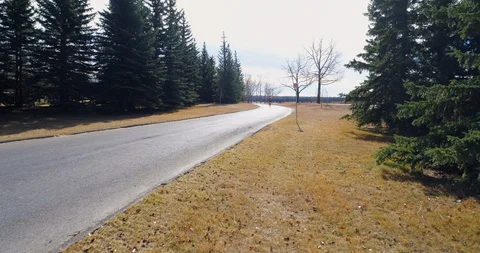 Cyclist cycling through a country road i... | Stock Video | Pond5