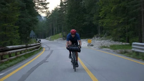 Cyclist with red helmet cycling over asp... | Stock Video | Pond5
