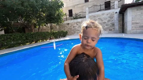 Dad jumps diving into the water in the p... | Stock Video | Pond5