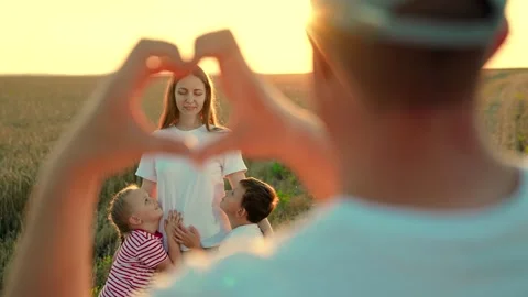 Dad Looking through Heart symbol made by... | Stock Video | Pond5