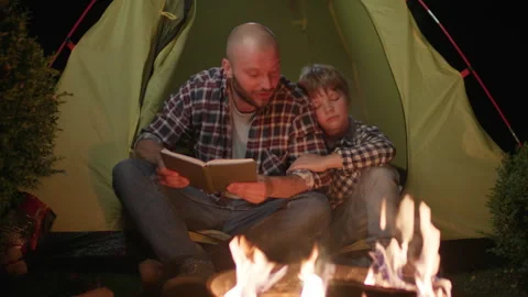 Dad Reading Book to Sleepy Kid sitting i... | Stock Video | Pond5