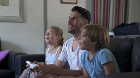 Daddy with kids playing video game at ho... | Stock Video | Pond5