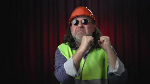 Dancing construction worker in a helmet | Stock Video | Pond5