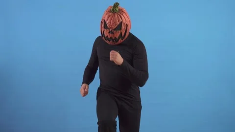Dancing pumpkin man on a blue background | Stock Video | Pond5
