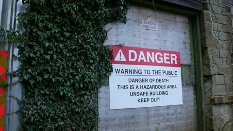 A danger sign on a derelict abandoned bu... | Stock Video | Pond5