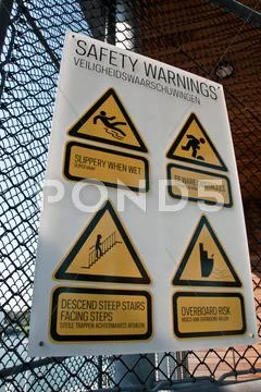 Danger warning signs hanging on a metal grid ~ Premium Photo #47365594