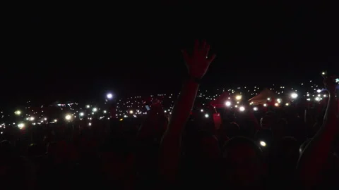 Dark background with concert crowd wavin... | Stock Video | Pond5