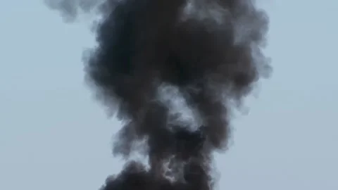 Dark black smoke in front of blue sky ba... | Stock Video | Pond5