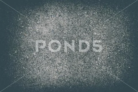 Photograph: Dark black stone road surface with black vignette ...