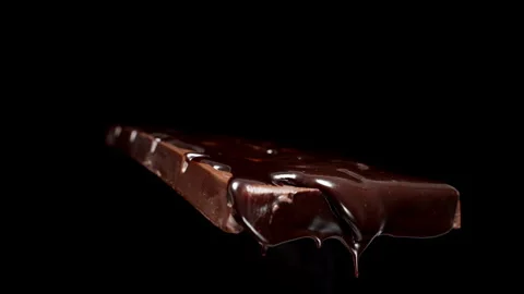 A dark chocolate bar on a black backgrou... | Stock Video | Pond5