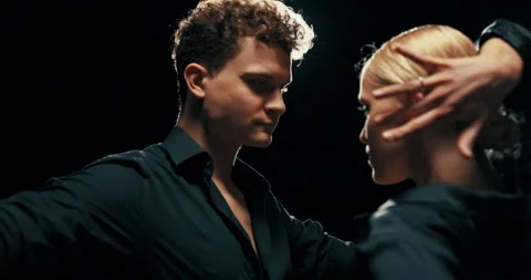 Dark scene studio shot of two people in ... | Stock Video | Pond5