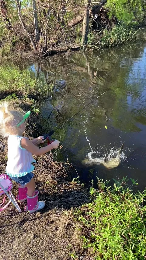 Daughter Reeling in First Fish Drops Pol... | Stock Video | Pond5
