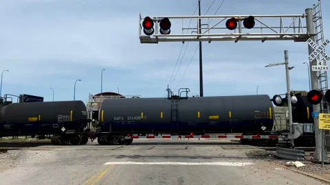 Daytime railroad crossing with oil tanke... | Stock Video | Pond5